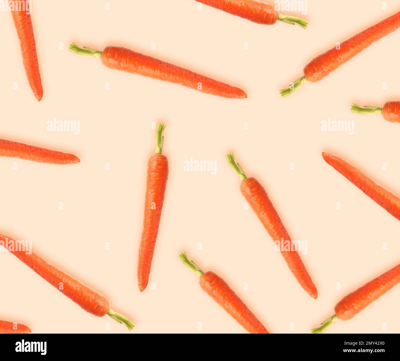 Whole carrots on beige background. Pattern design Stock Photo - Alamy