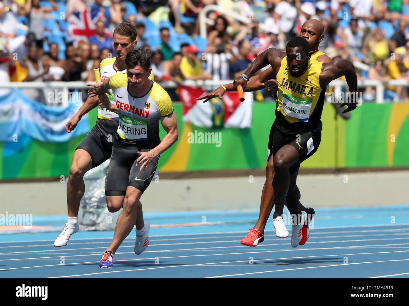 Jamaica's Nickel Ashmeade, right, takes the baton from Asafa Powell as ...