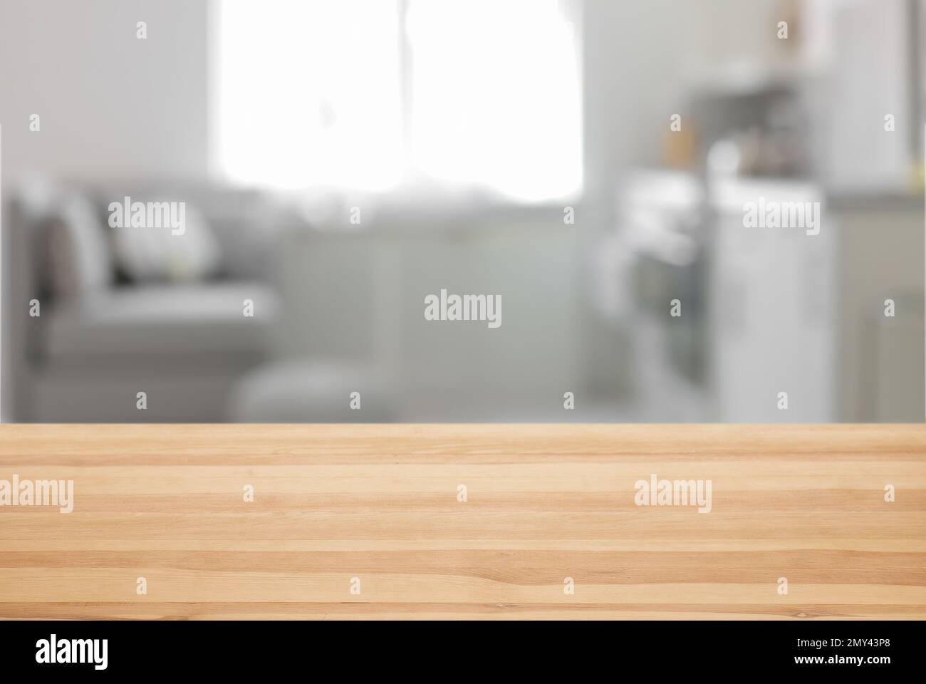 Wooden desk and blurred room on background. Home furniture Stock Photo ...