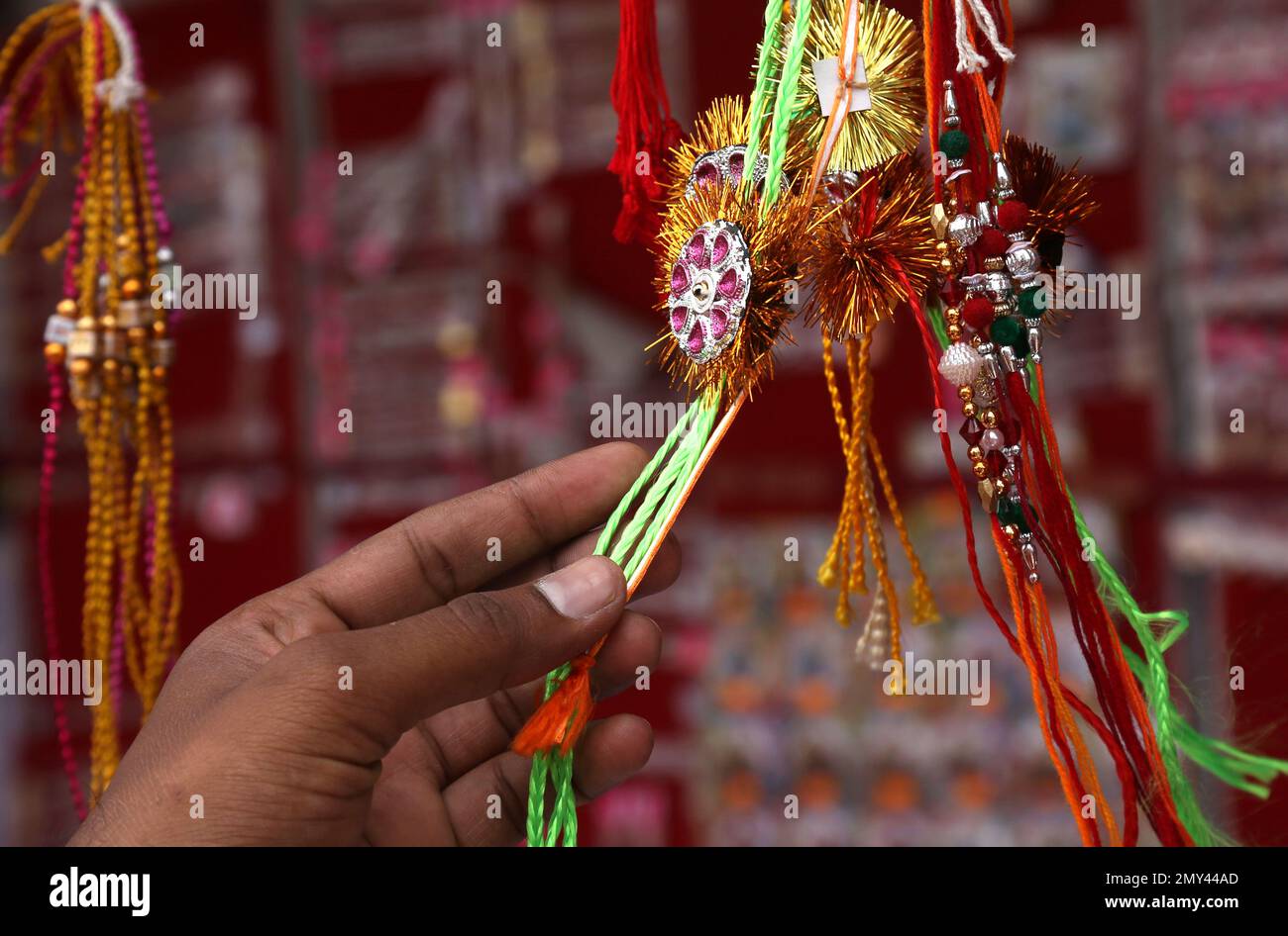 An Indian woman buys 'rakhi' during the Hindu festival of Raksha ...