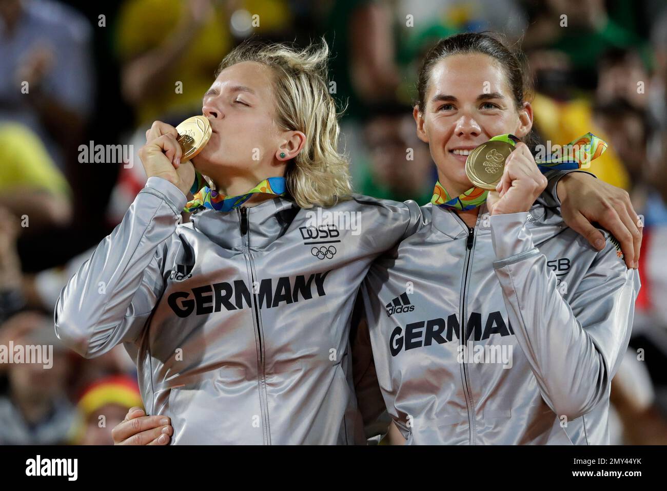 Germany's Laura Ludwig, left, and teammate Kira Walkenhorst stand on ...