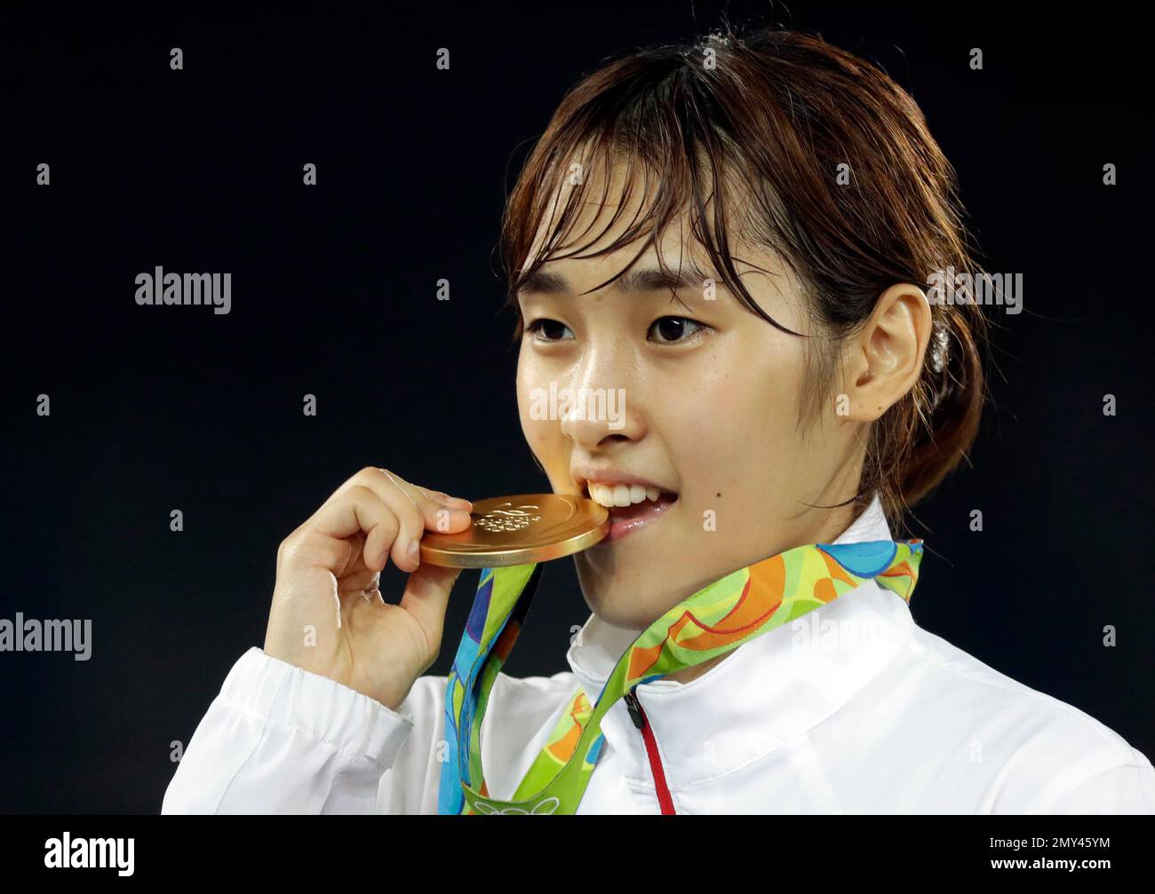 Kim Sohui of South Korea bite the gold medal she won in the women's ...