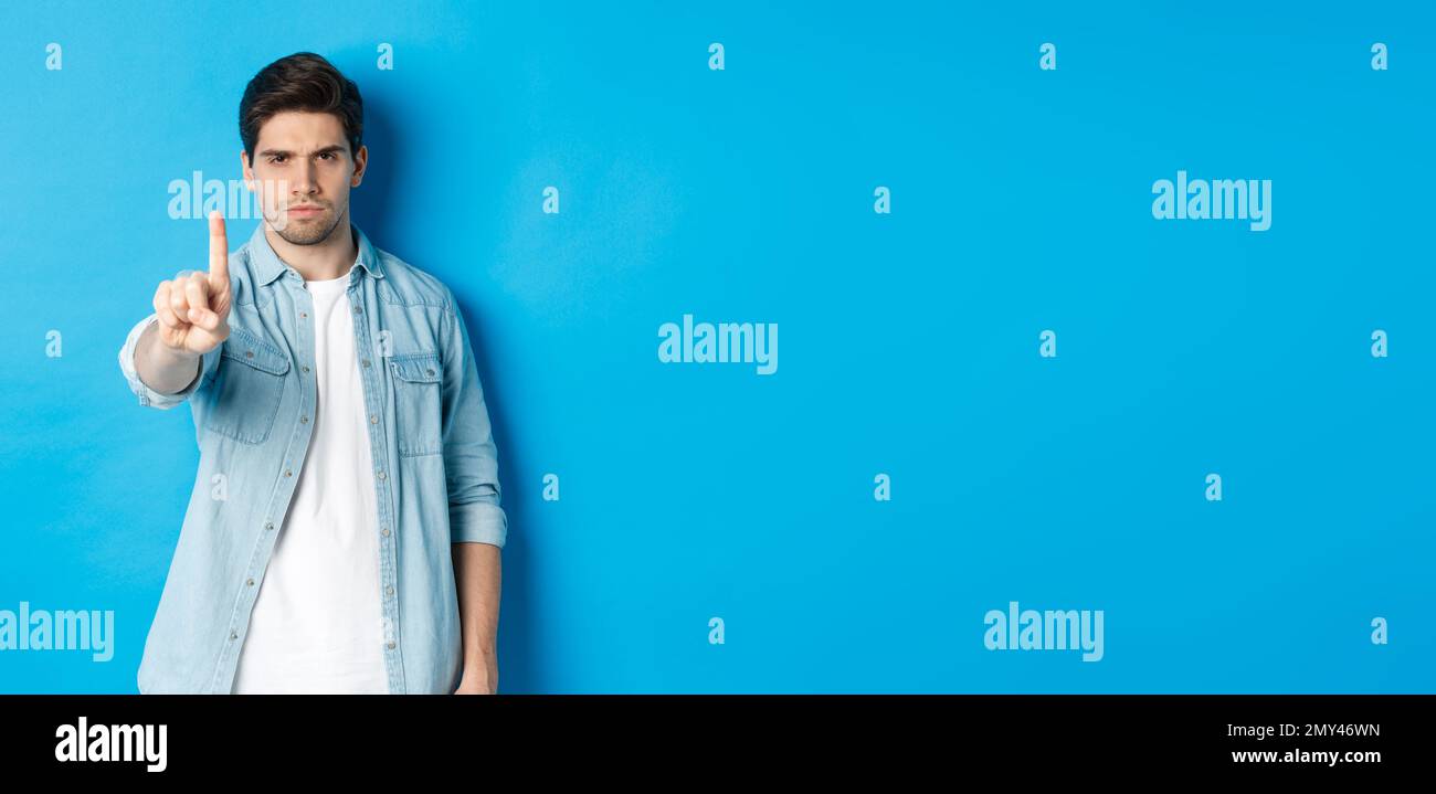 Angry 25 years old man shaking finger in disapproval sign, frowning ...