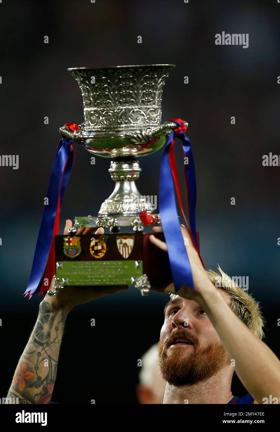 FC Barcelona's Lionel Messi celebrates with the trophy after winning ...