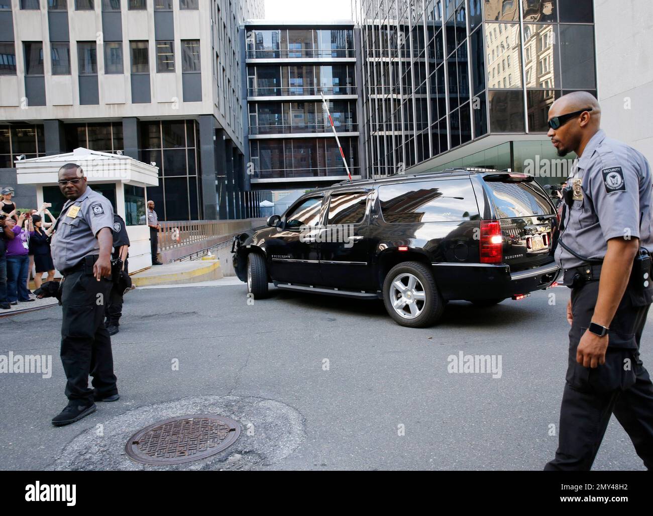 Security officers patrol a street in front of a garage of the Jacob K ...