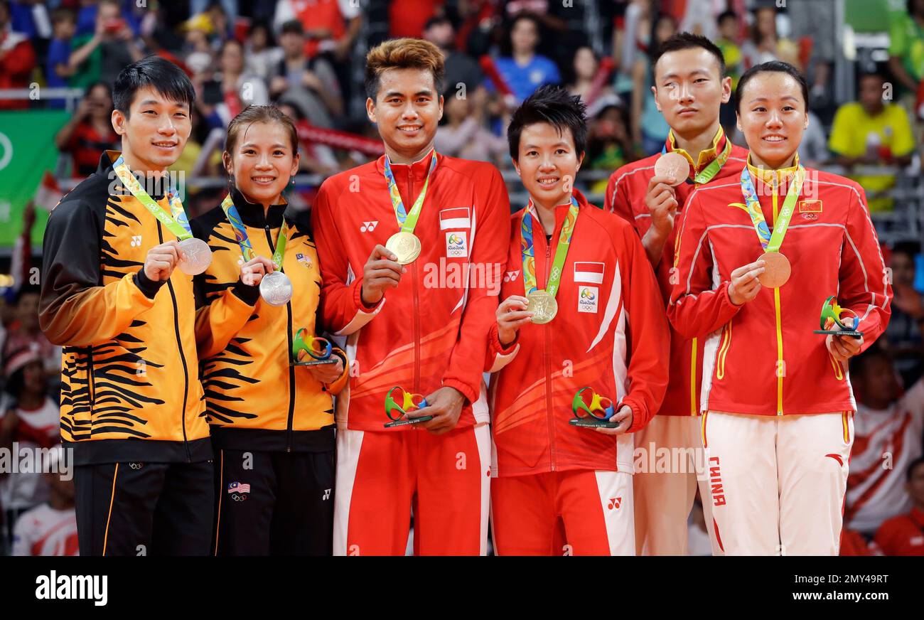 The badminton mixed doubles medal winners stand on the winners' stand ...