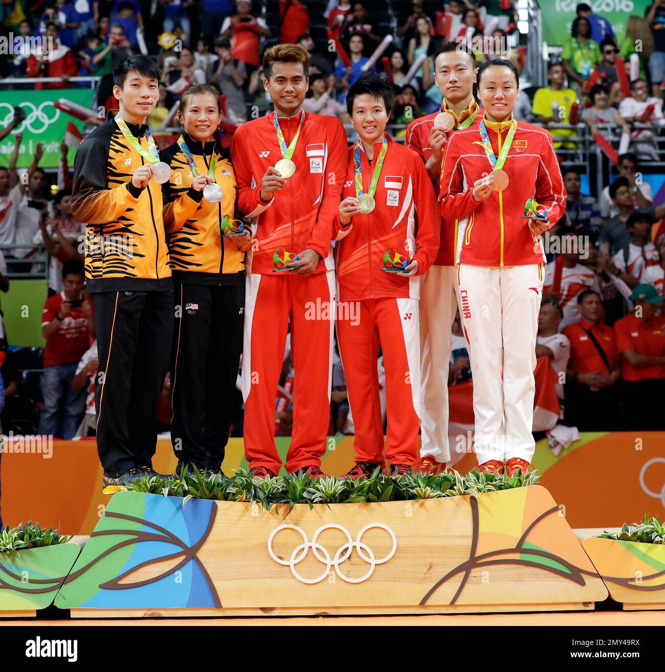 The badminton mixed doubles medal winners stand on the winners' stand ...