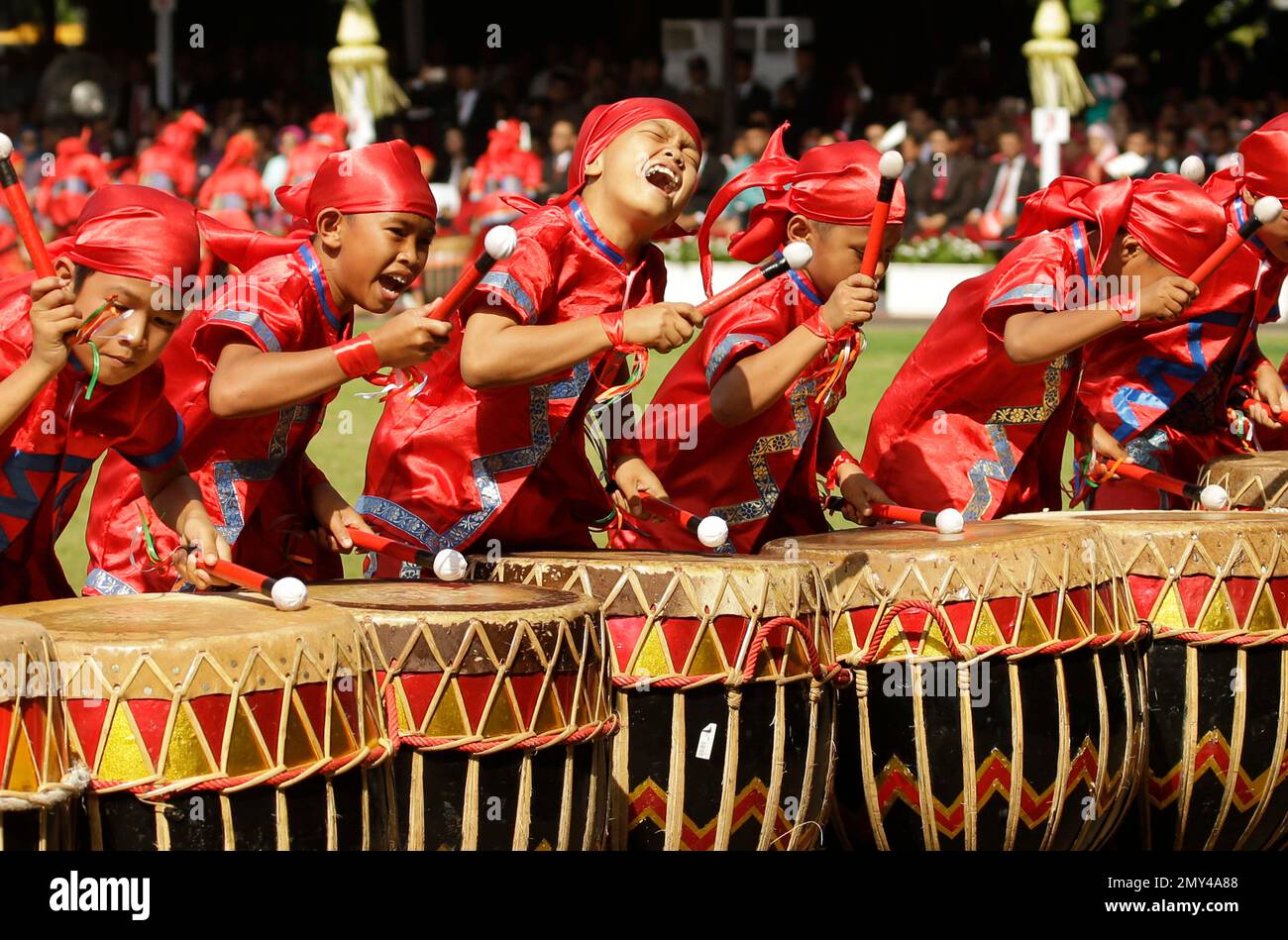 Indonesian youths play drums during a ceremony held to commemorate the ...