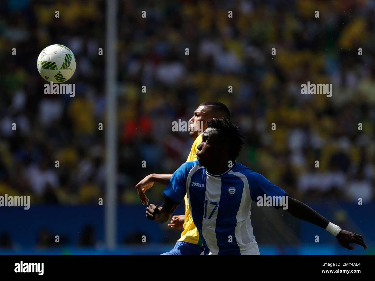 Brazil's Walace, center left, and Honduras' Brayan Ramirez eye the ball ...
