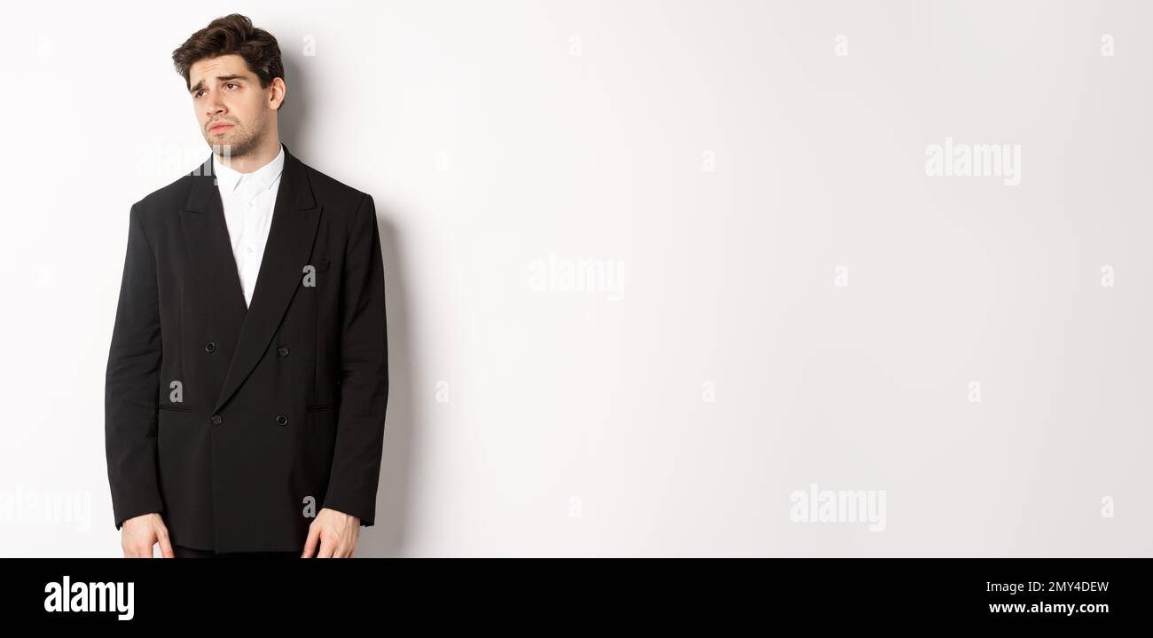 Image of tired man in suit looking left with distressed, gloomy ...