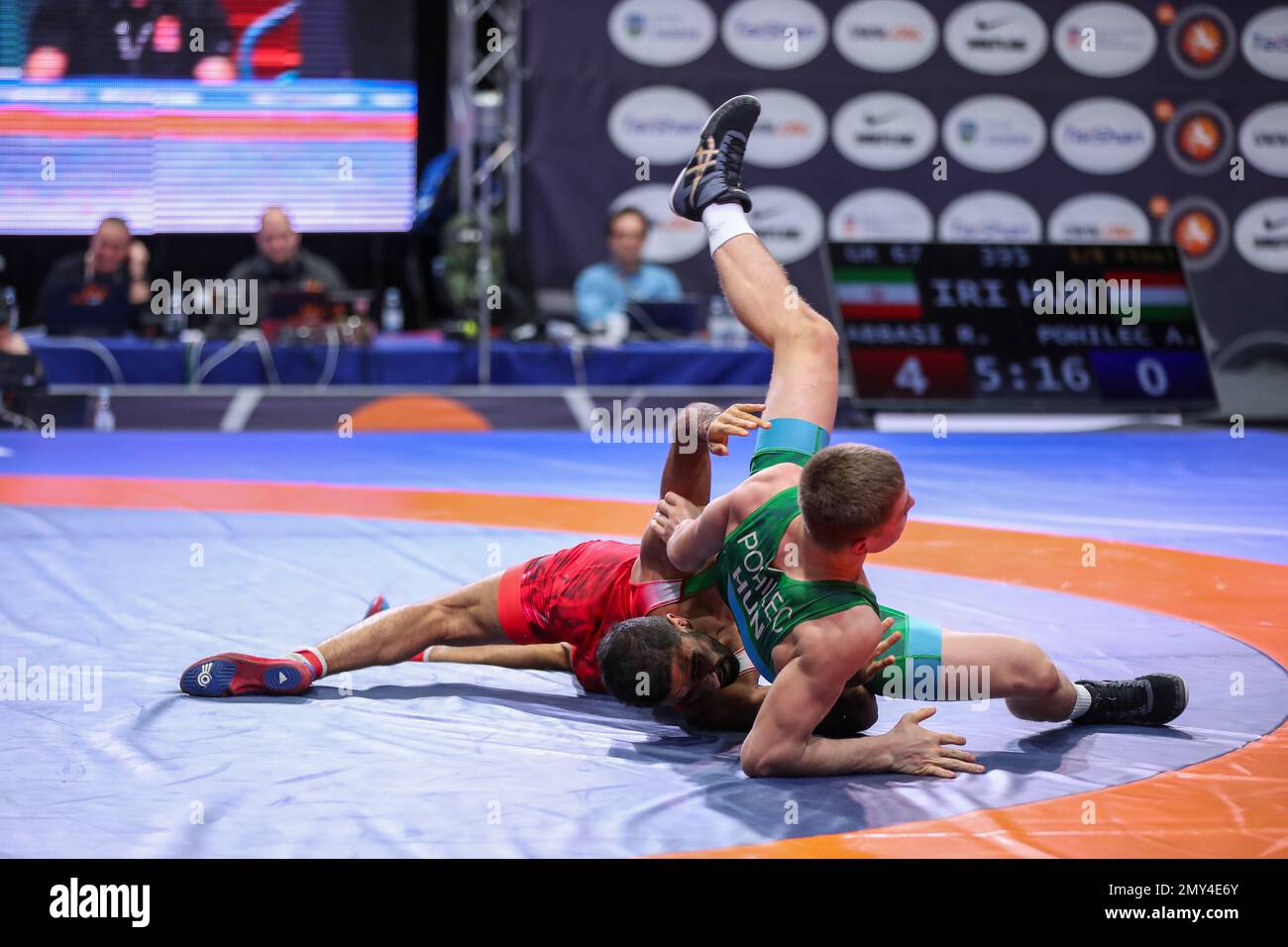 ZAGREB, CROATIA – FEBRUARY 04: Reza Mahdi Abbasi of Iran (red) competes ...