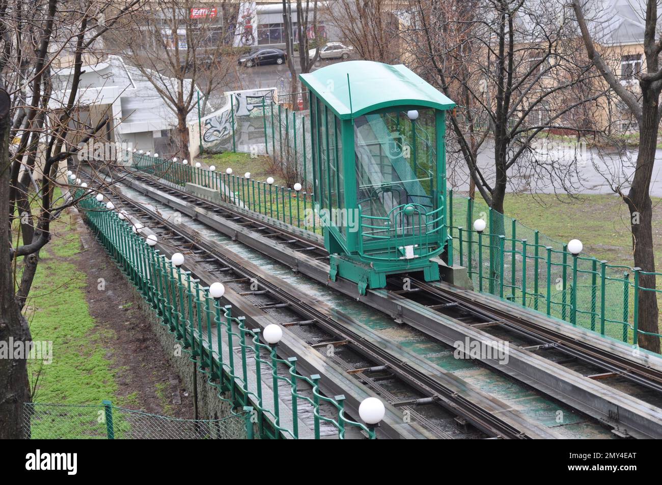 The green funicular trailer moves along the rails on the slope in Kyiv ...