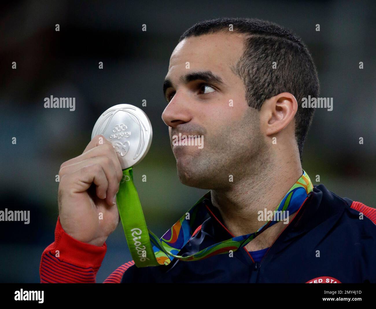 United States' Danell Leyva displays his silver medal for the parallel ...