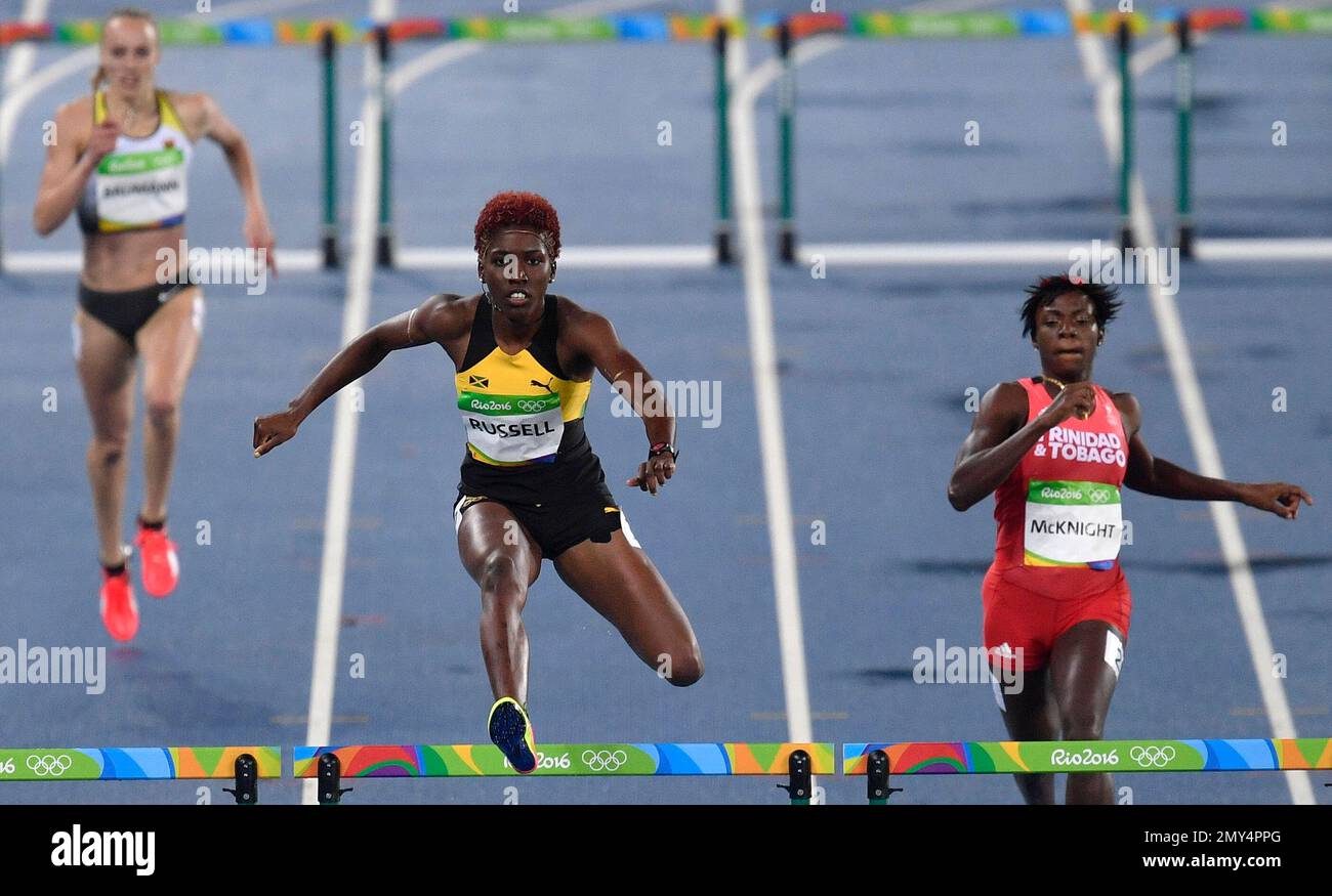Janieve Russell of Jamaica, center, competes in a women's 400-meter ...
