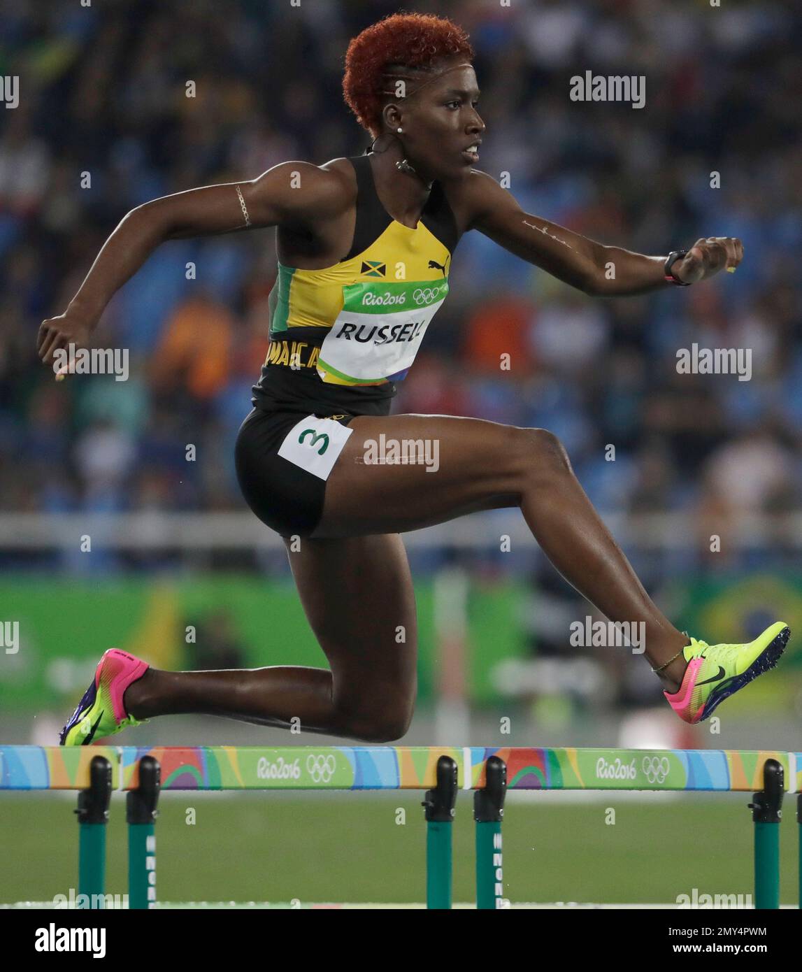 Janieve Russell of Jamaica competes in a women's 400-meter hurdles heat ...