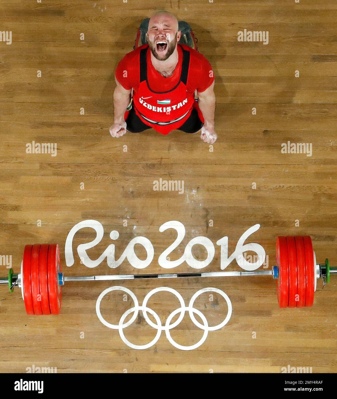 Ruslan Nurudinov, of Uzbekistan, celebrates after winning the gold ...