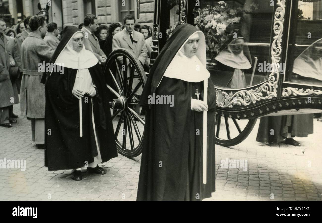 Traditional Italian catholic church funeral with wagon, procession and ...