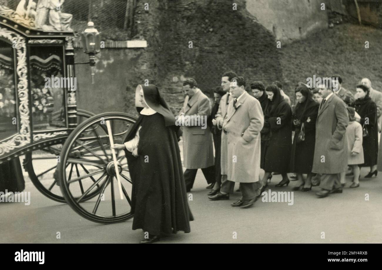 Traditional Italian catholic church funeral with wagon, procession and ...