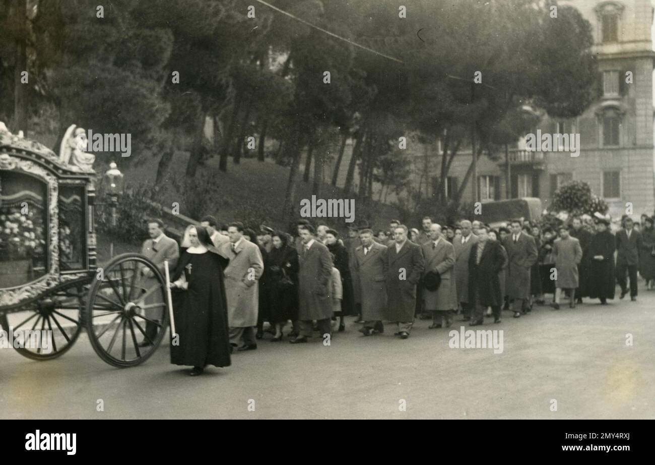 Traditional Italian catholic church funeral with wagon, procession and ...