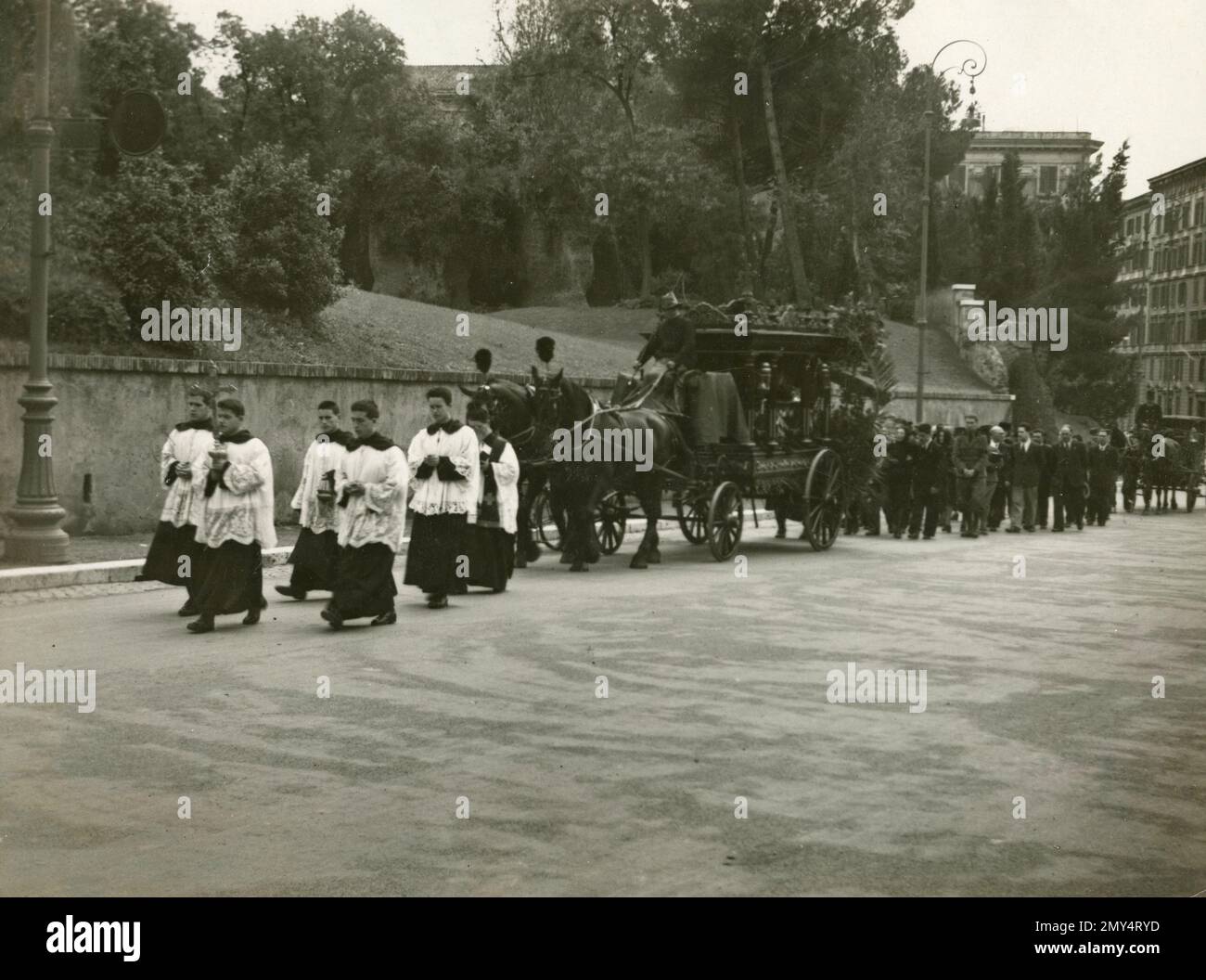 Procession with altar boys and wagon at a funeral, Italy 1930s Stock ...