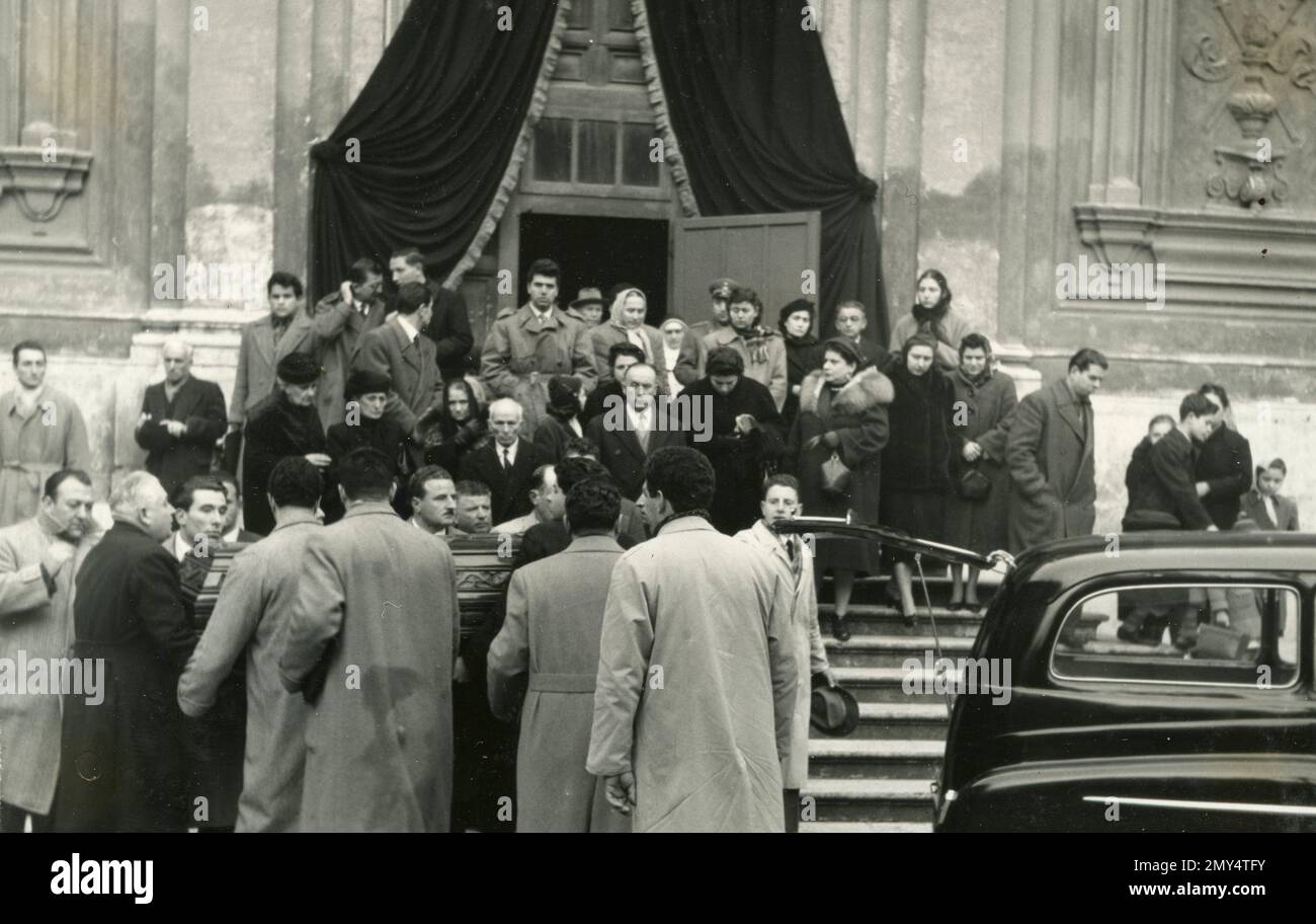 Traditional Italian catholic church funeral with wagon, procession and ...
