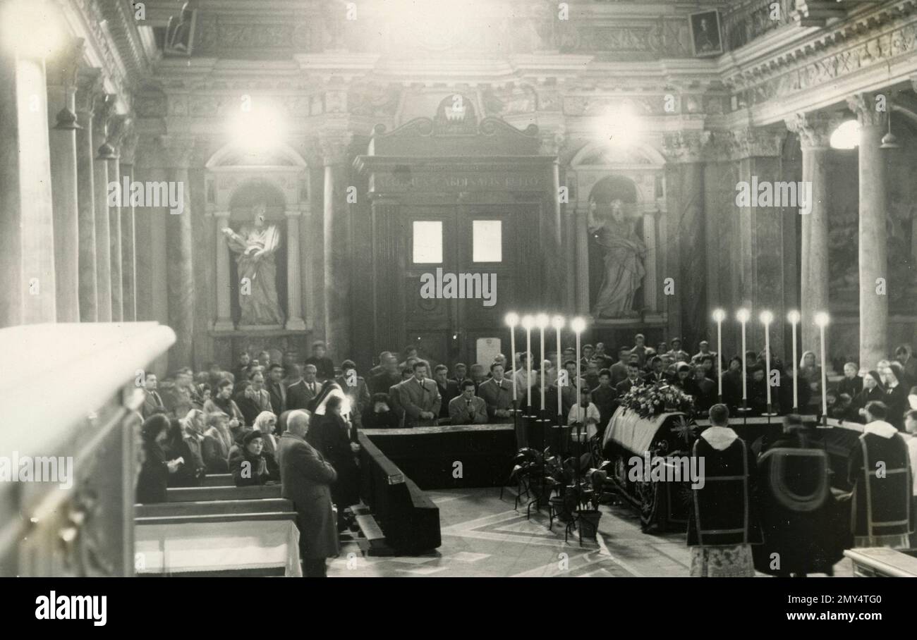 Traditional Italian catholic church funeral with wagon, procession and ...