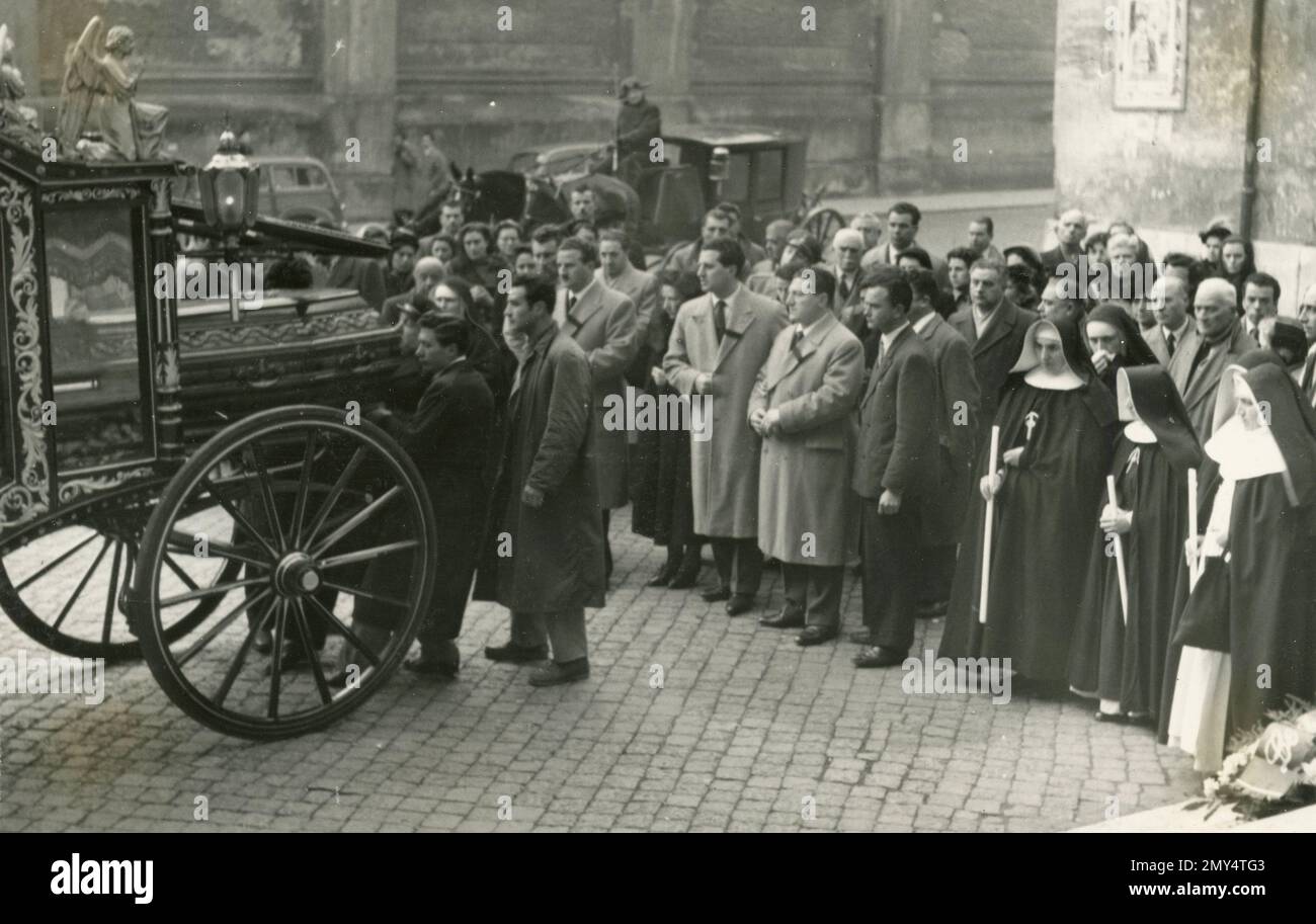 Traditional Italian catholic church funeral with wagon, procession and ...
