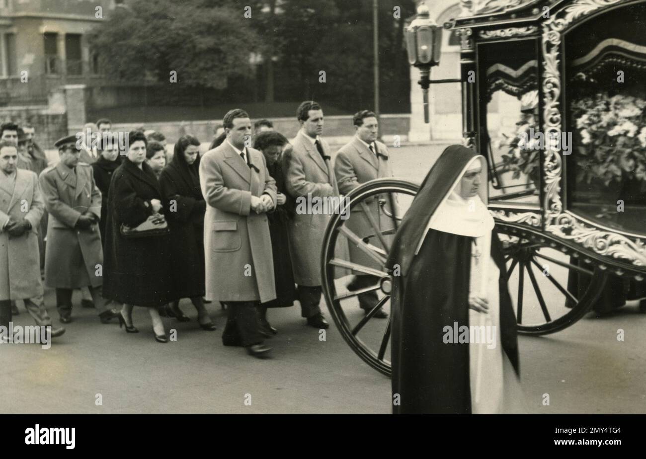 Traditional Italian catholic church funeral with wagon, procession and ...