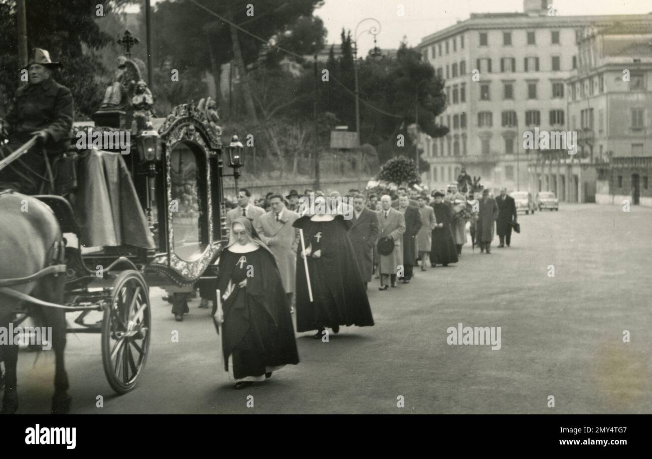 Traditional Italian catholic church funeral with wagon, procession and ...