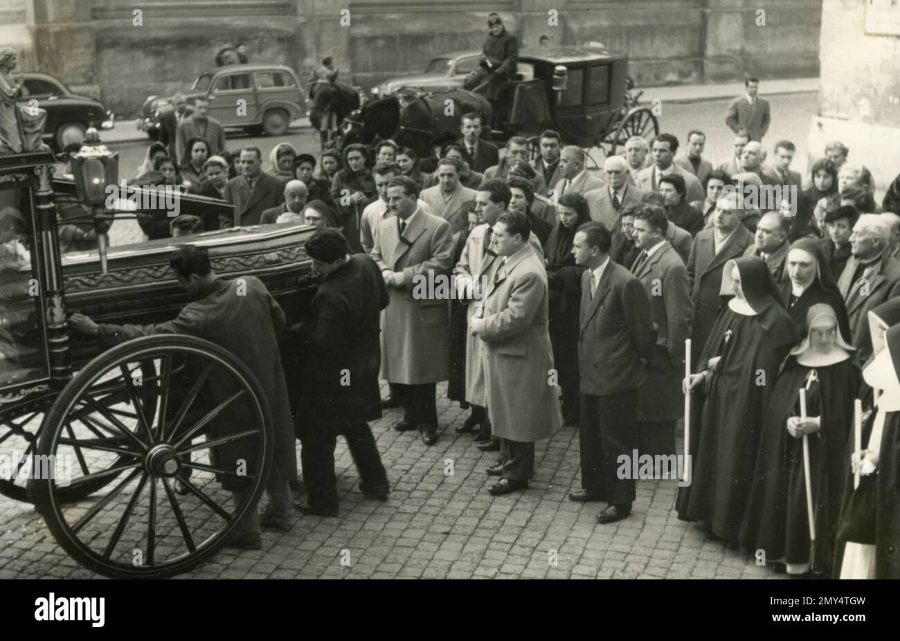 Traditional Italian catholic church funeral with wagon, procession and ...