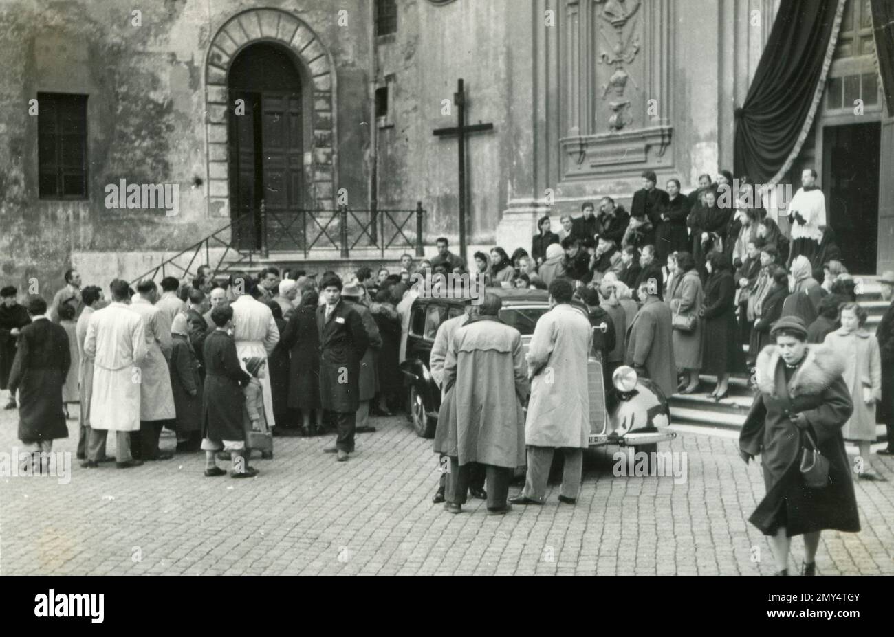 Traditional Italian catholic church funeral with wagon, procession and ...
