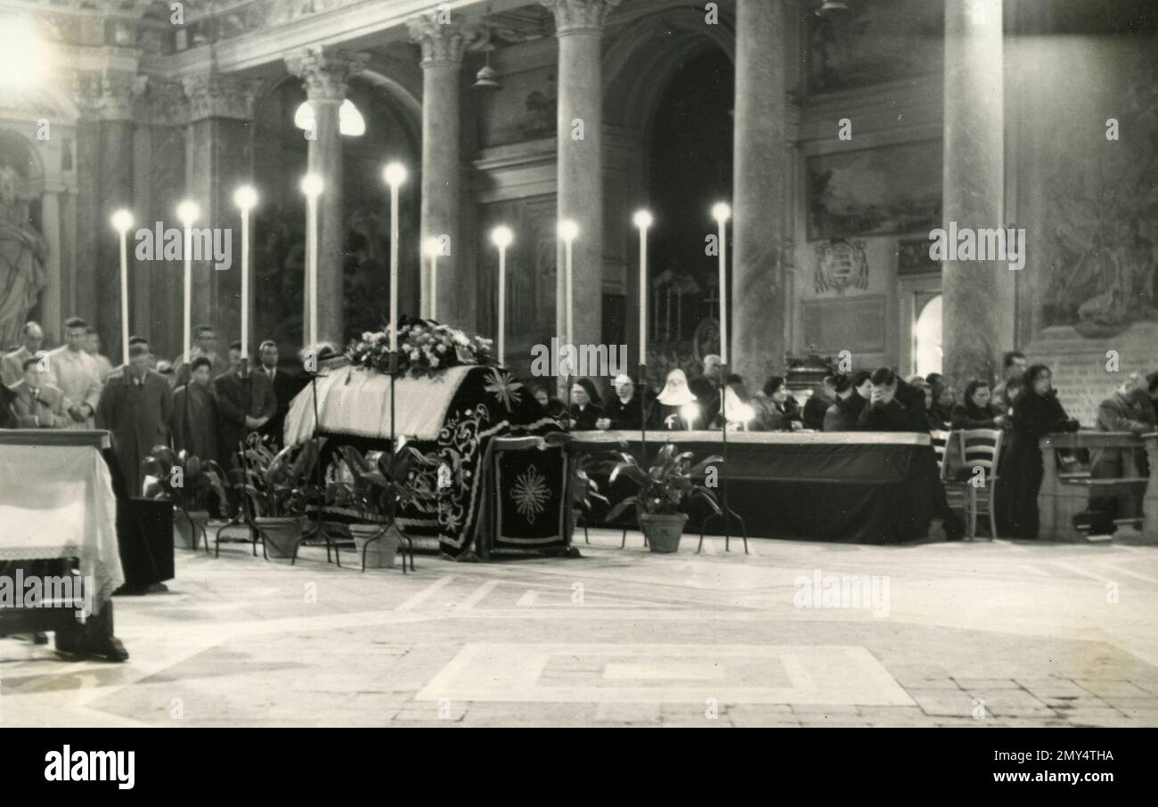Traditional Italian catholic church funeral with wagon, procession and ...