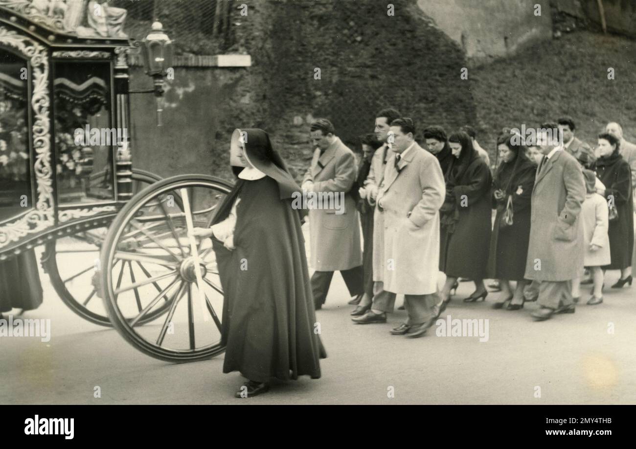 Traditional Italian catholic church funeral with wagon, procession and ...
