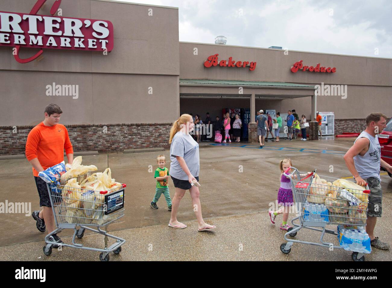 Eli Turnage, 14, left, helps the Creel family, from left to right ...