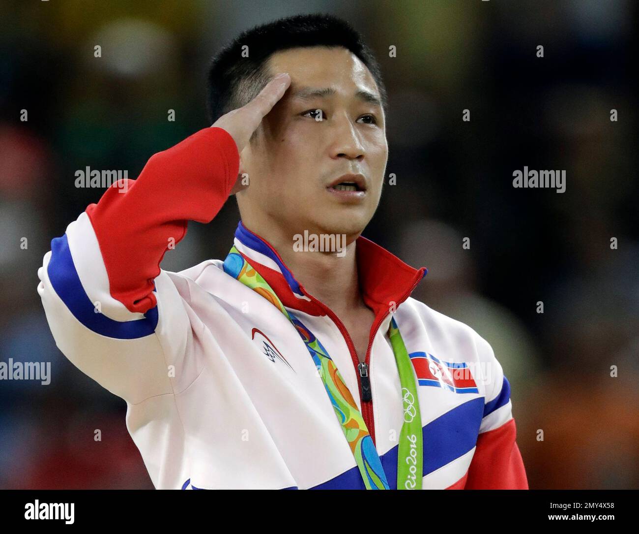North Korea's Ri Se Gwang salutes as his national anthem is played ...