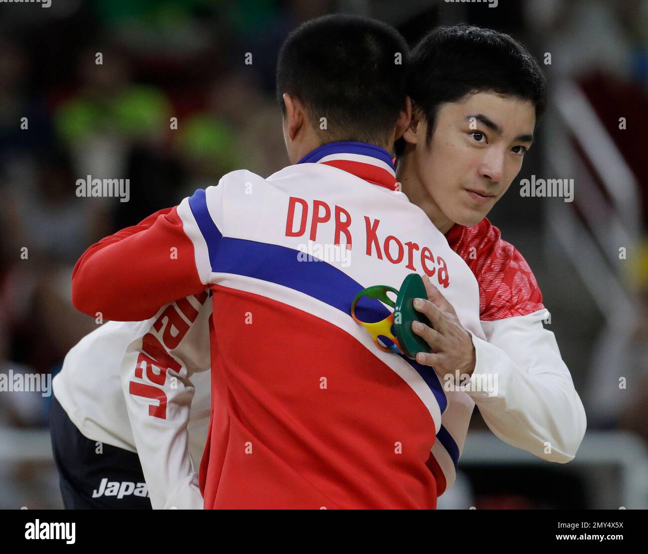 Japan's Kenzo Shirai, bronze winner, embraces North Korea's Ri Se Gwang ...
