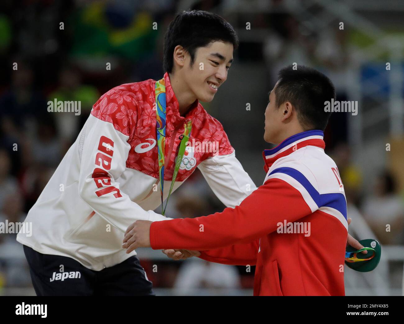 Japan's Kenzo Shirai, bronze winner, embraces North Korea's Ri Se Gwang ...