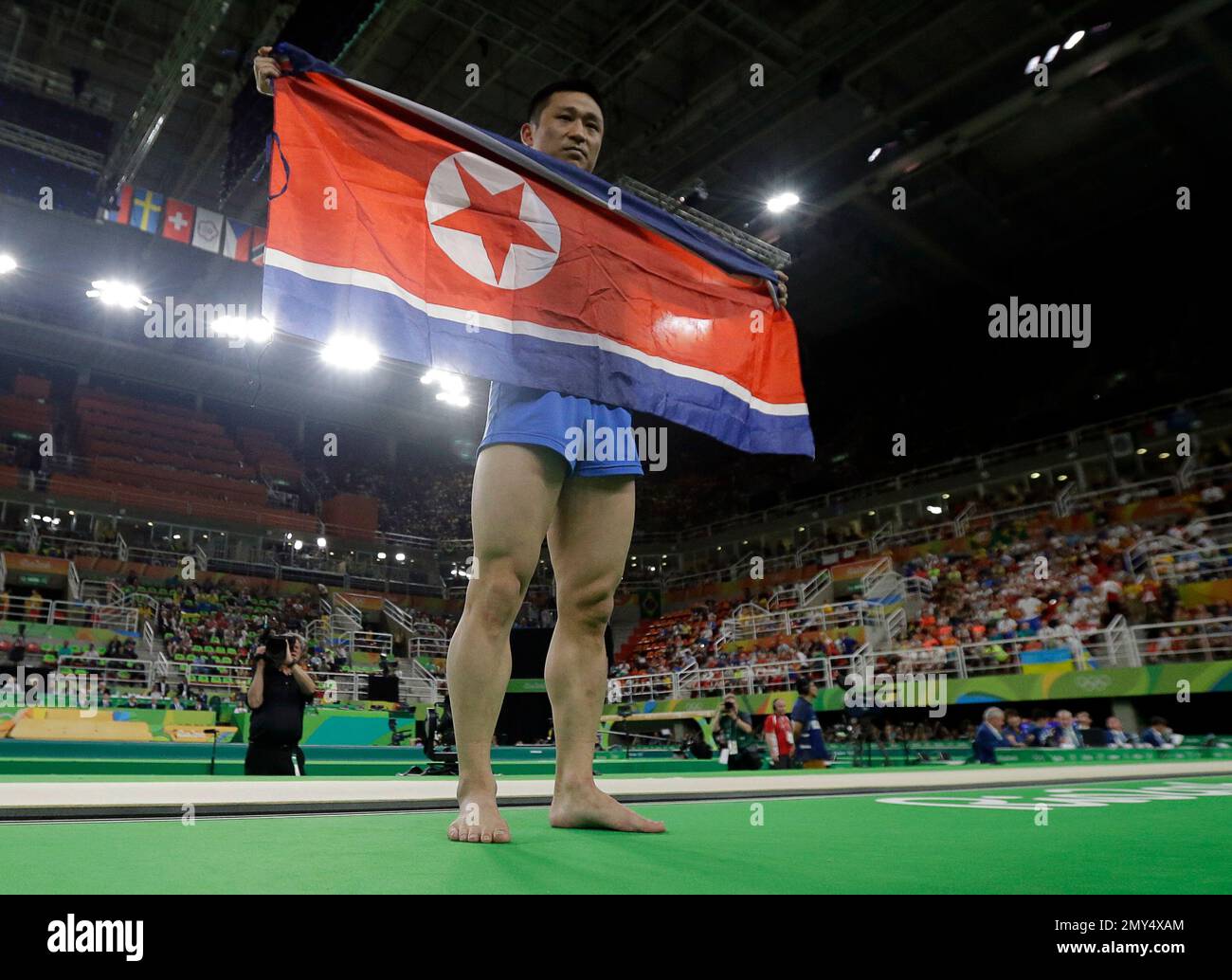 North Korea's Ri Se Gwang stands with his national flag after winning ...