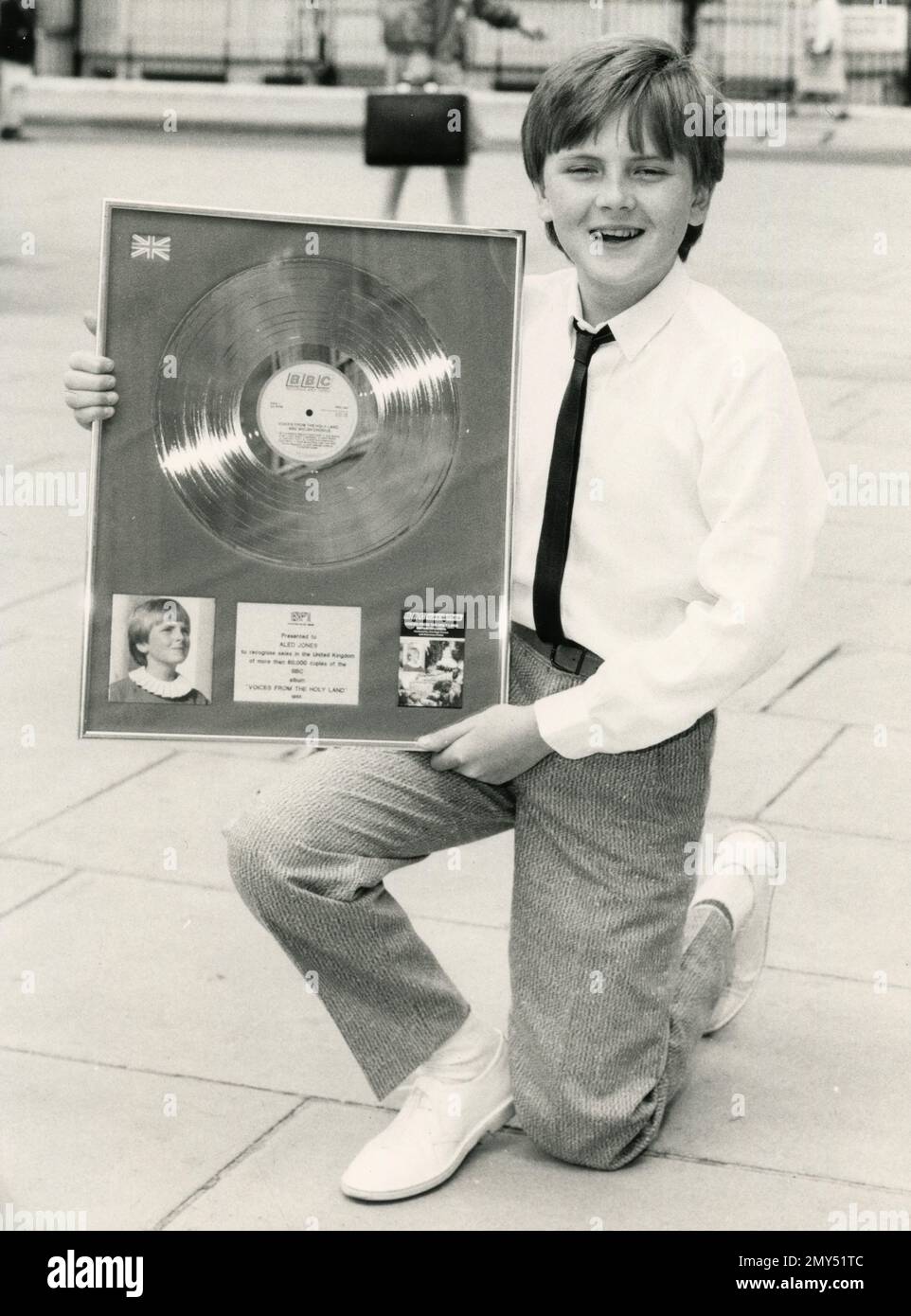 Welsh choirboy Aled Jones holding a silver disc award to mark the sales ...
