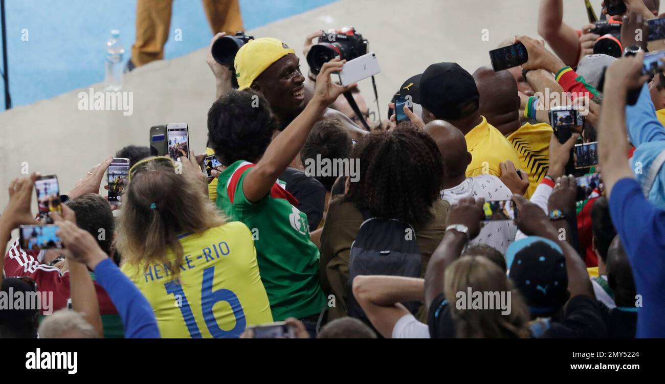 Jamaica's Usain Bolt greets spectators after winning the men's 100 ...