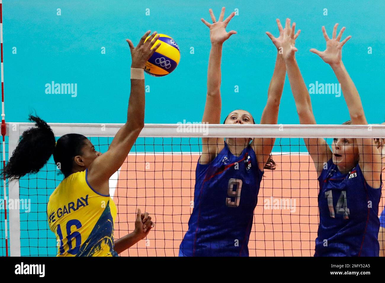Brazil's Fernanda Rodrigues, left, spikes the ball as Russia's Vera ...