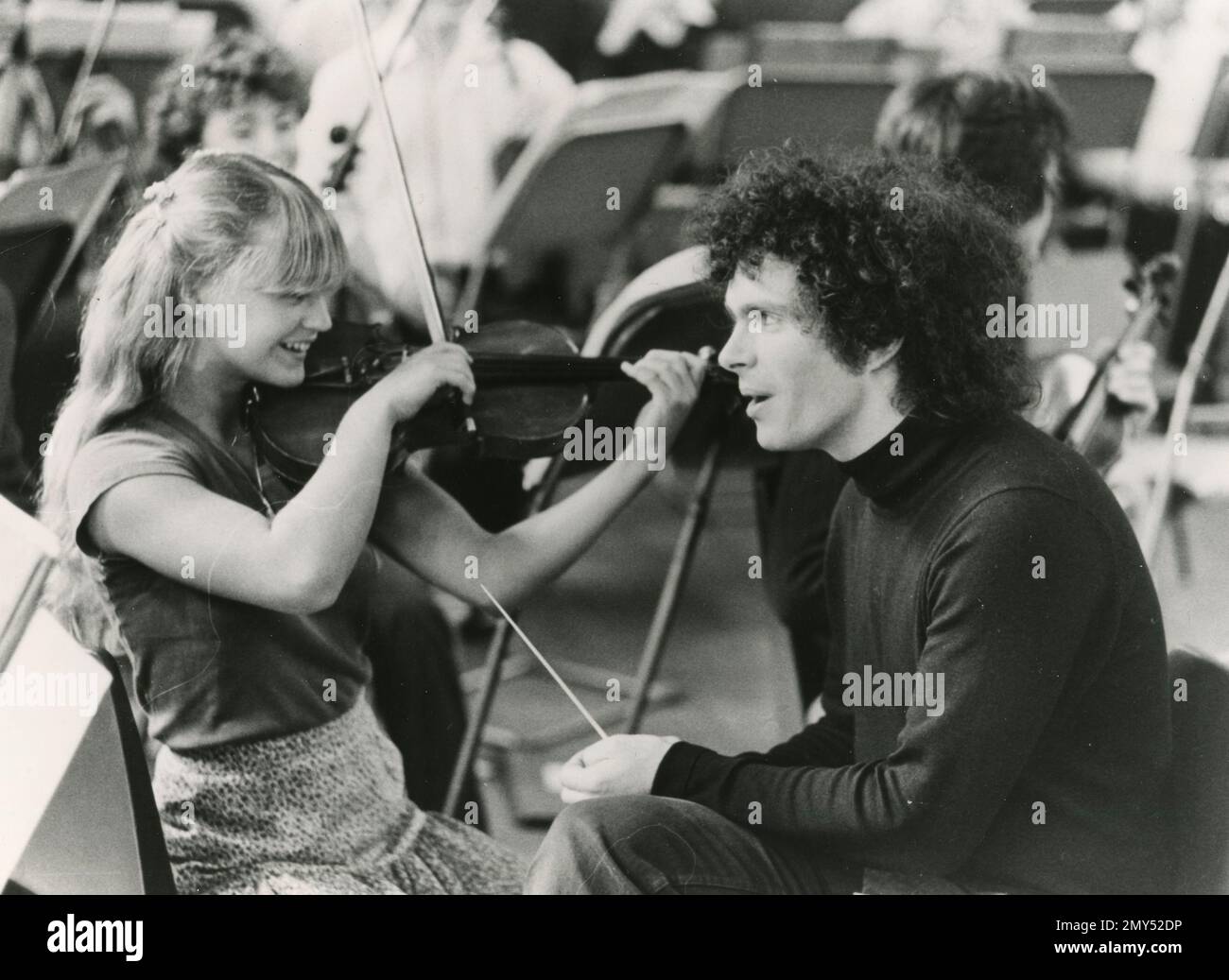 A young violinist appreciating the comment of British conductor Simon ...