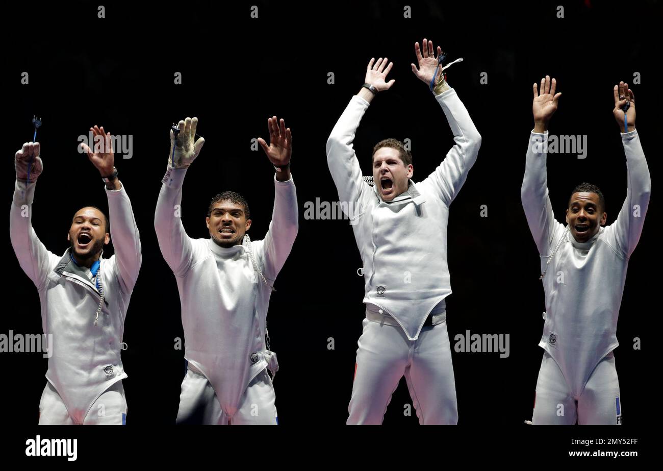 Fencers of the French team celebrate after defeating Italy in a men's ...