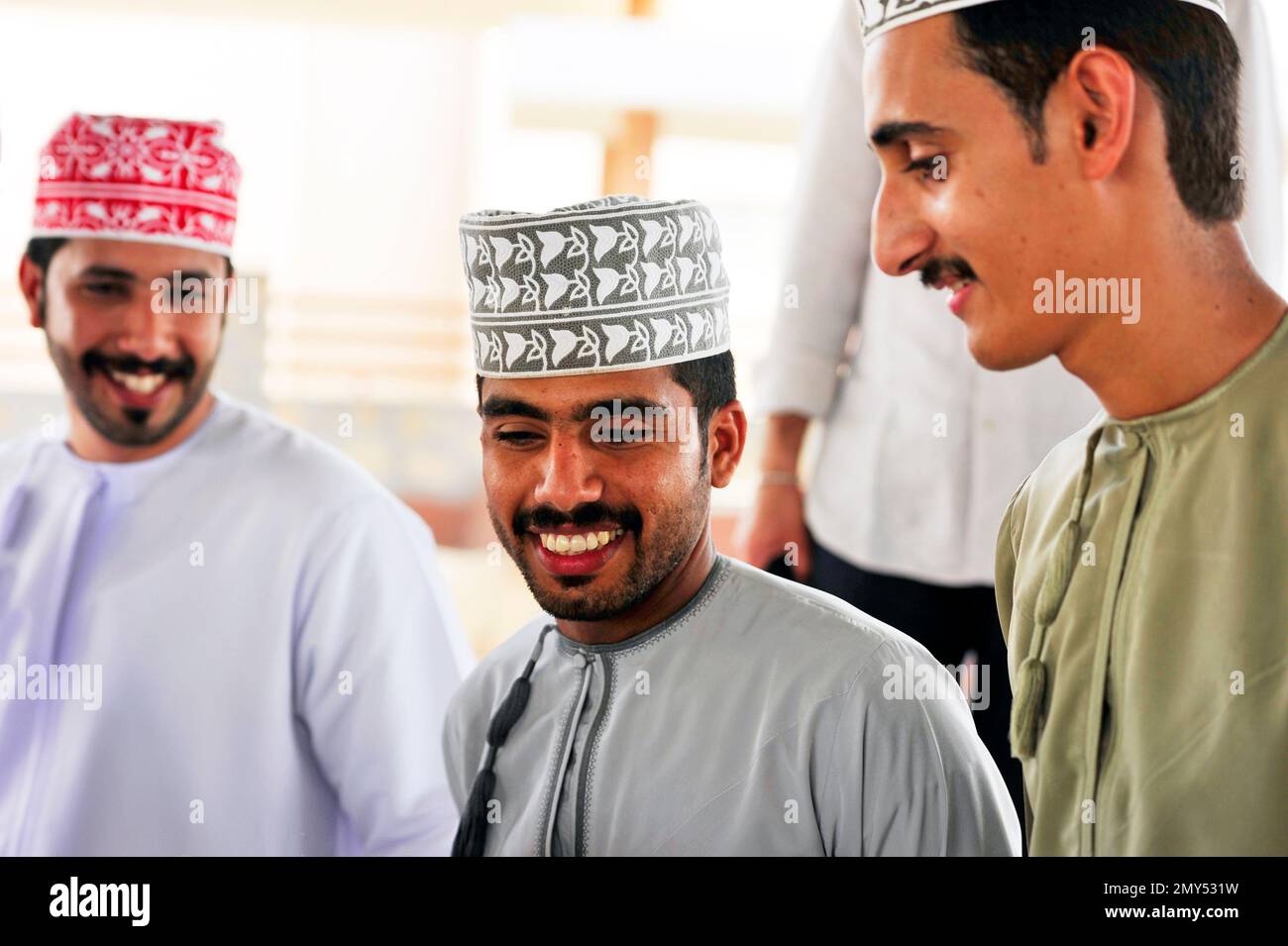 Ordinary people, traditionally dressed, at the Nizwa Livestock Market ...