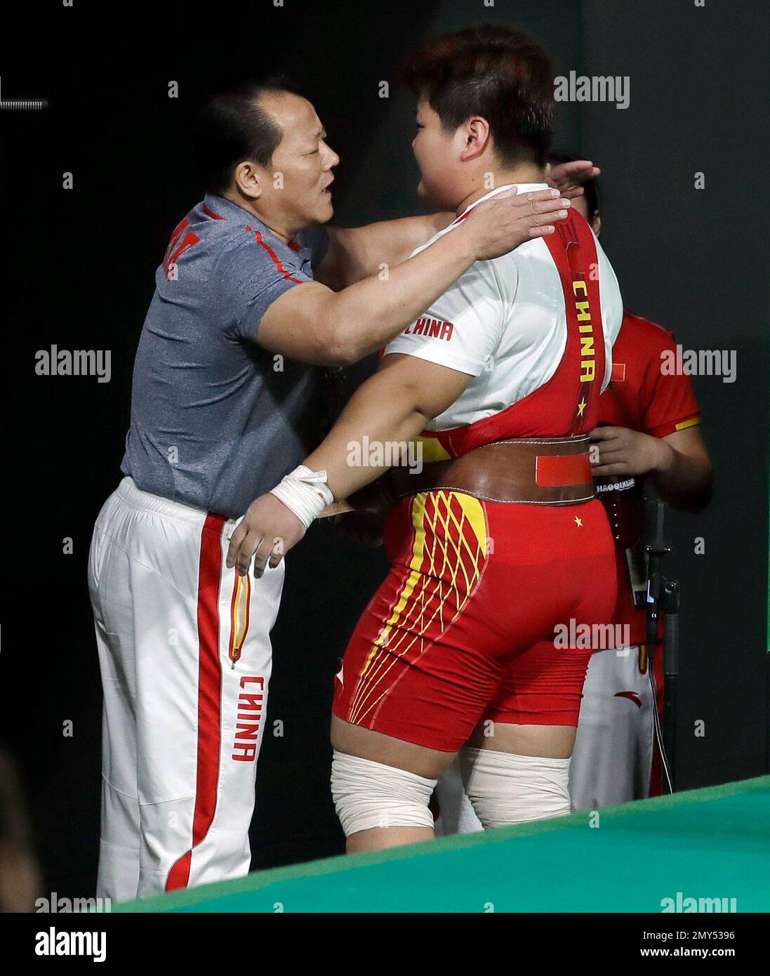 Meng Suping, of China, is congratulated after winning the gold medal in the women's 75kg ...