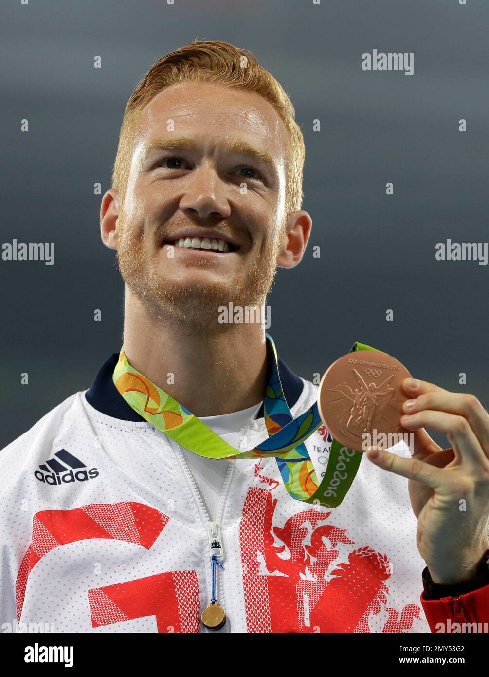 Britain's Greg Rutherford shows off his bronze medal during the long ...