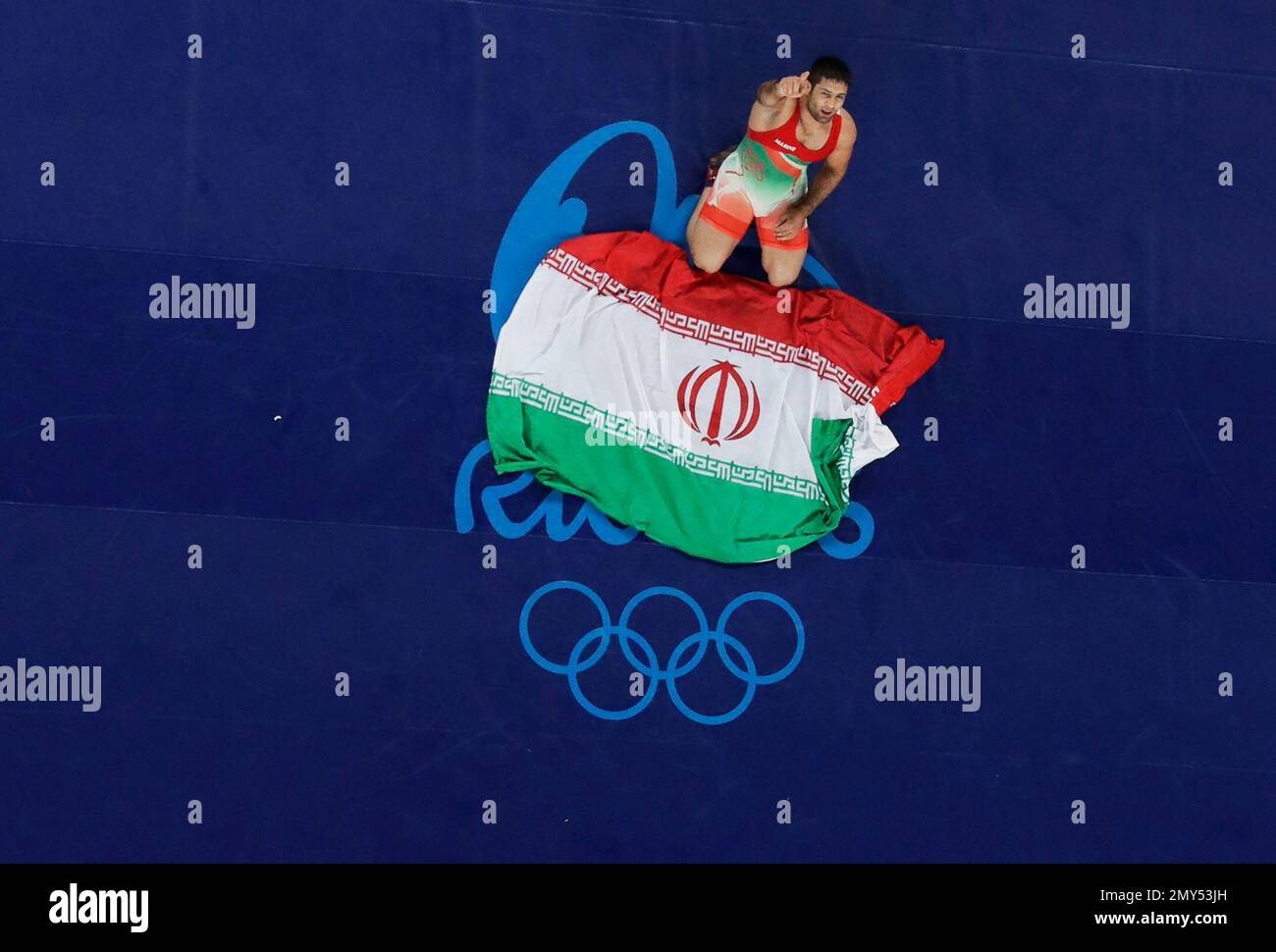 Iran's Saeid Morad Abdvali celebrates after winning the bronze medal ...