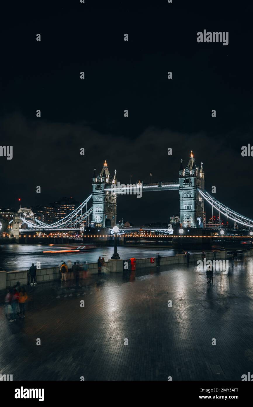 London Bridge over Thames in London by night with light trails long ...