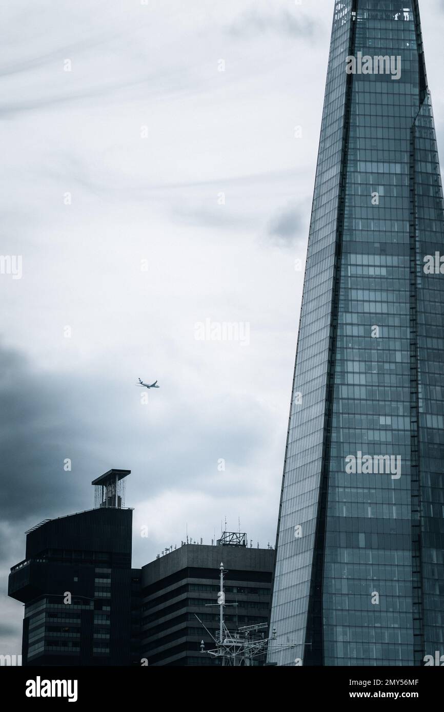 The Shard with a plane in the background flying in London United ...