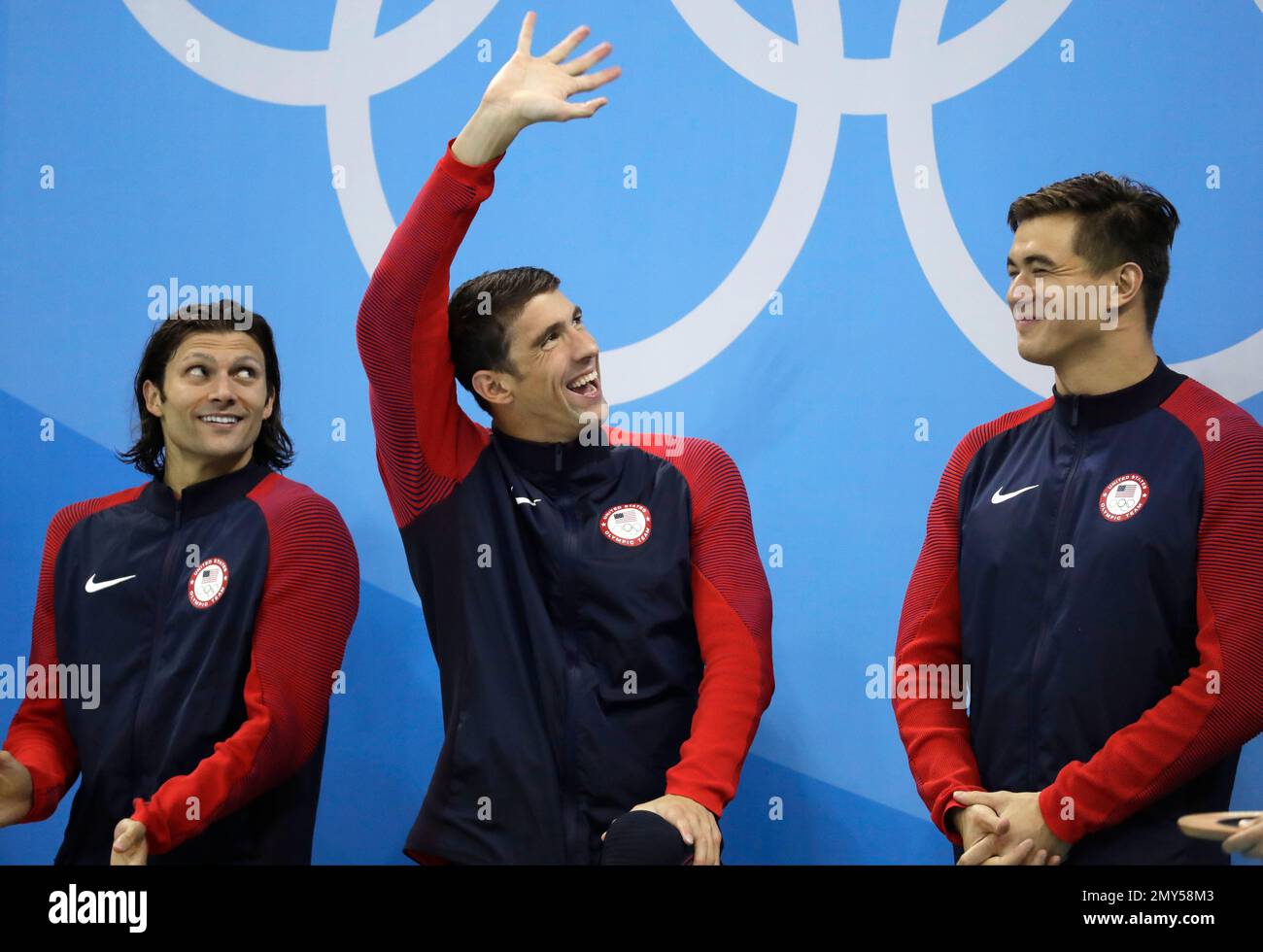 United States' Michael Phelps waves as teammates Cody Miller, left, and ...